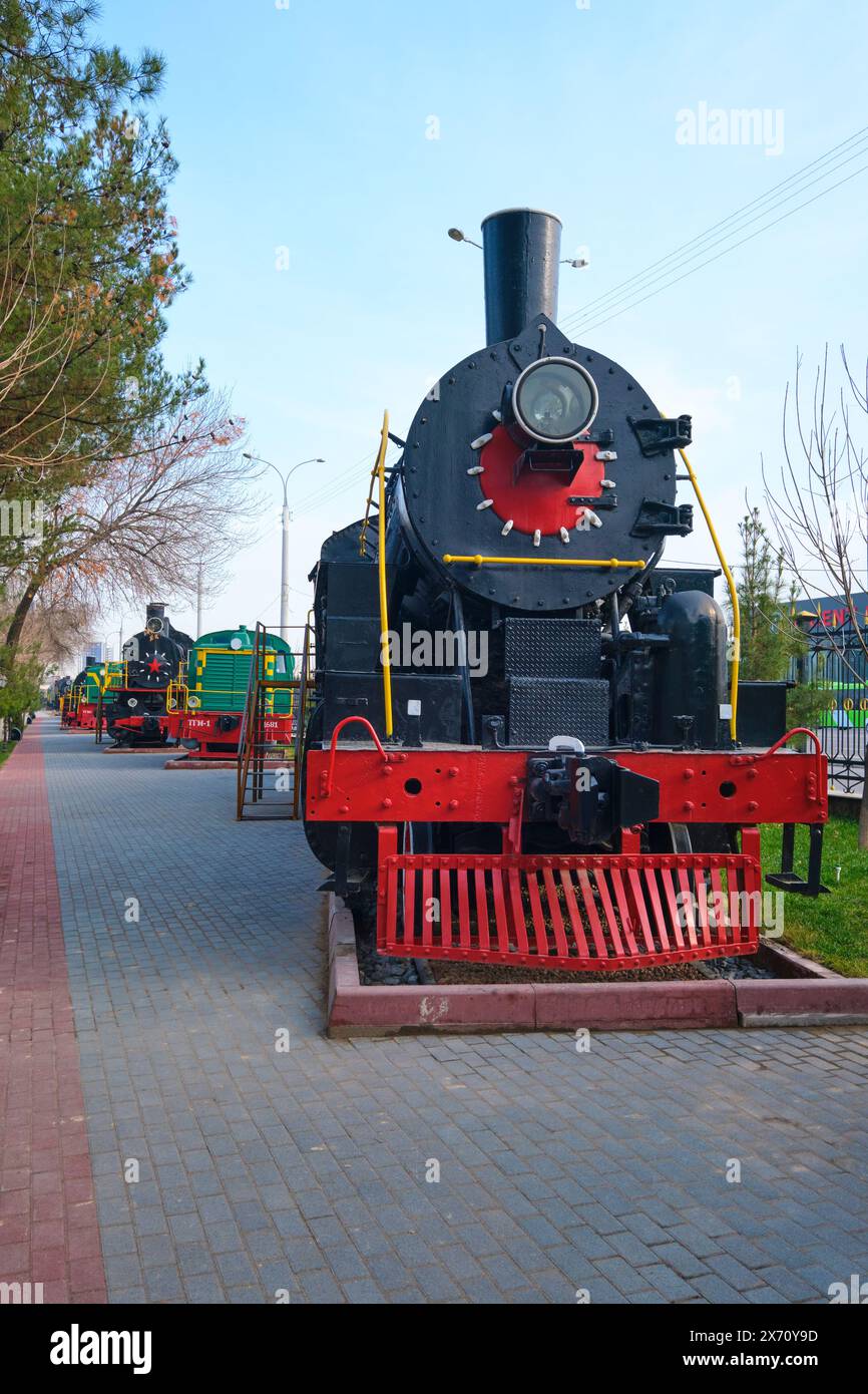 View of the front of an old steam, black locomotive with light. At the ...