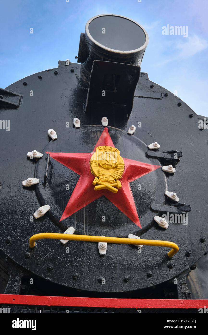 View of the front of an old steam, black locomotive with red star and ...