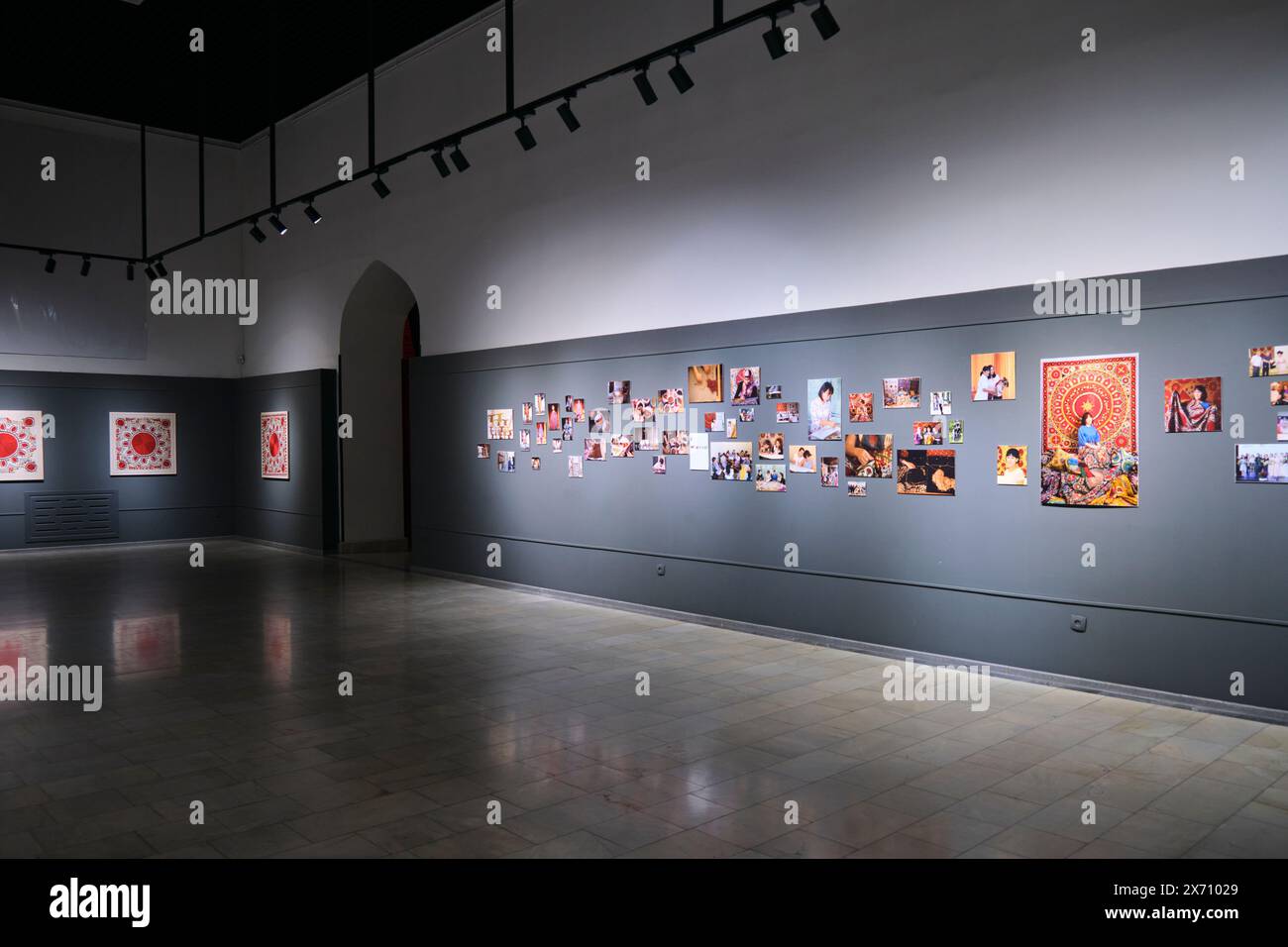 A wall of photographs, many examples of suzani design. At a suzani ...