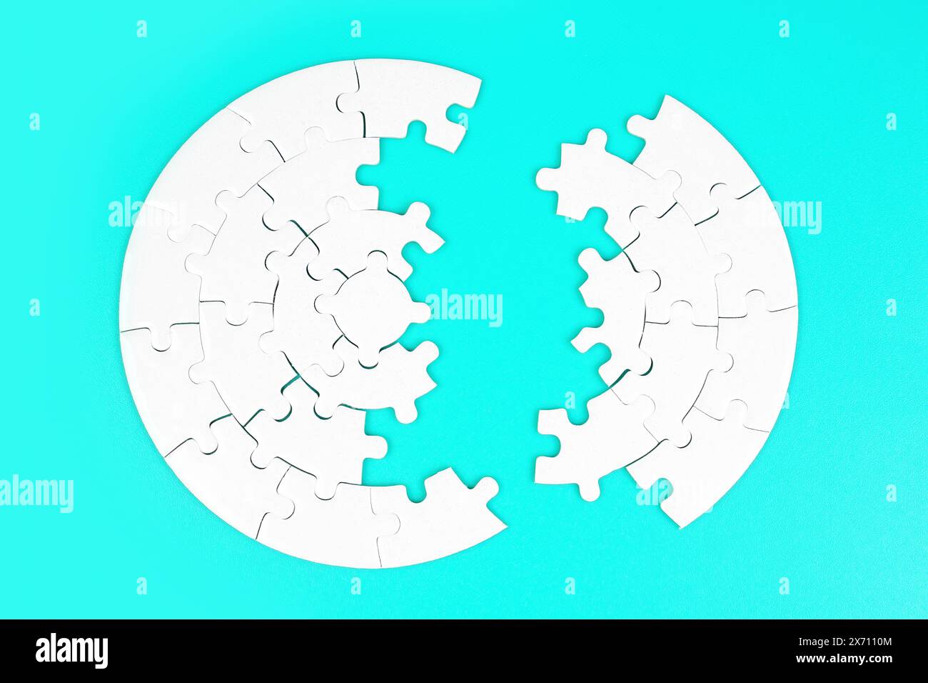 Top view of a blank circular jigsaw puzzle divided into two parts on a ...