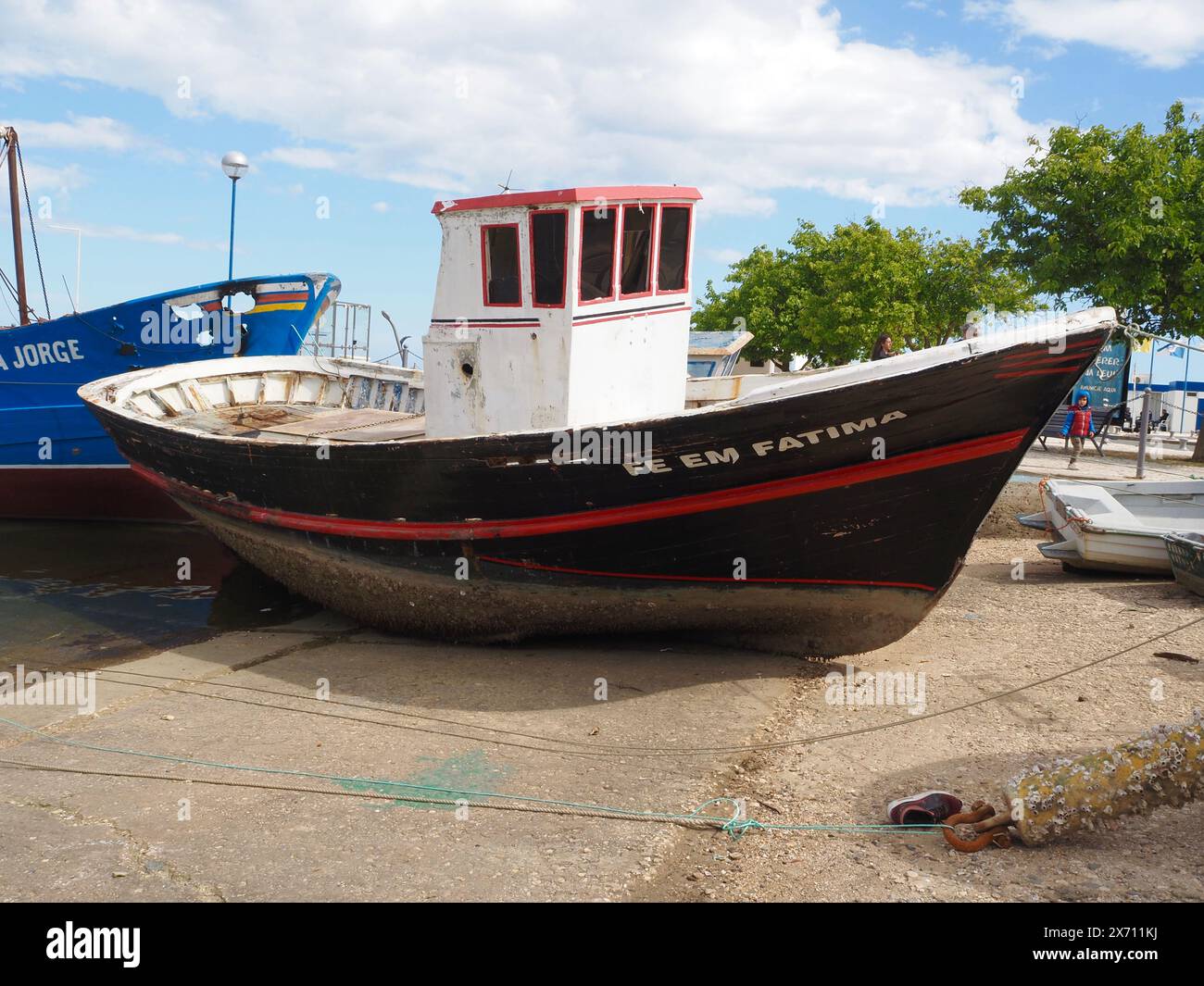 Black white and red wooden boat Fé em Fátima on slipway at Fuseta ...