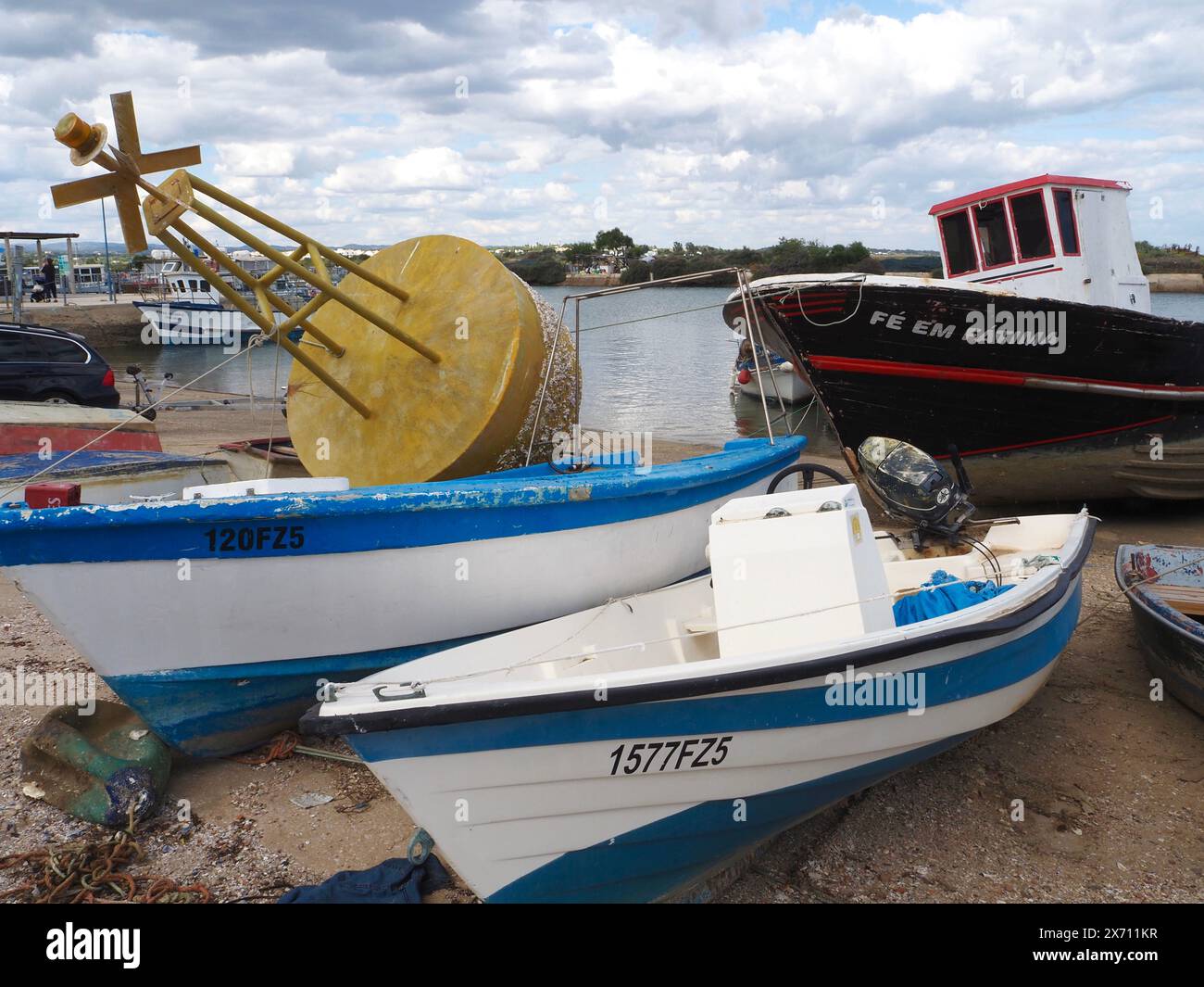 Small pleasure craft with yellow concrete land marker buoy in the ...