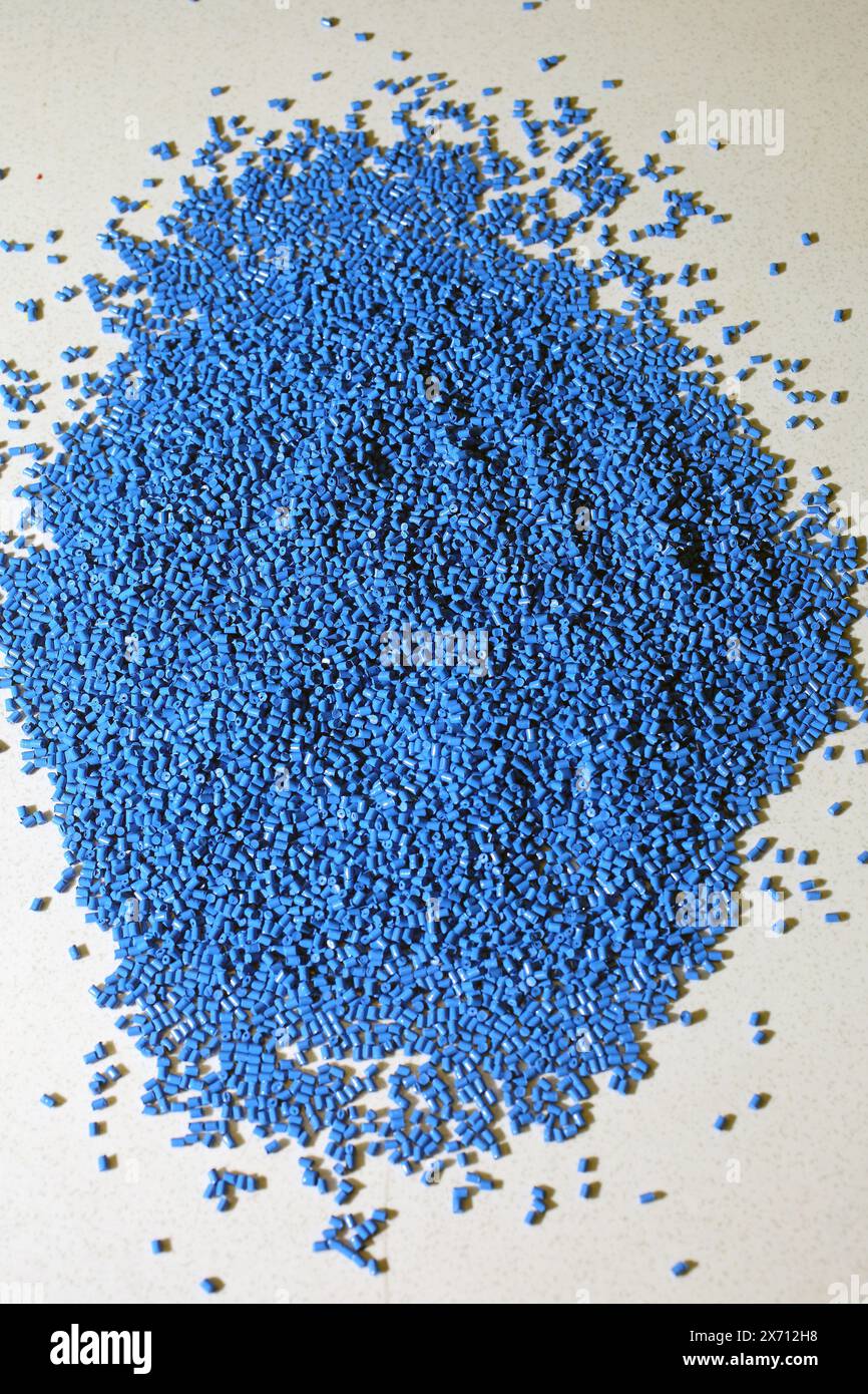 Pile of blue plastic polymer granules isolated on white background ...