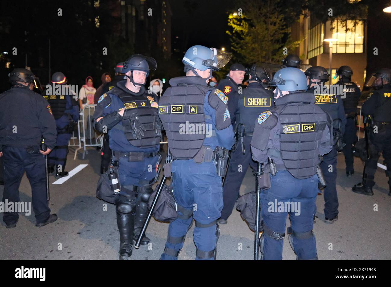 Police officers with full gear gather on the streets near the UC ...