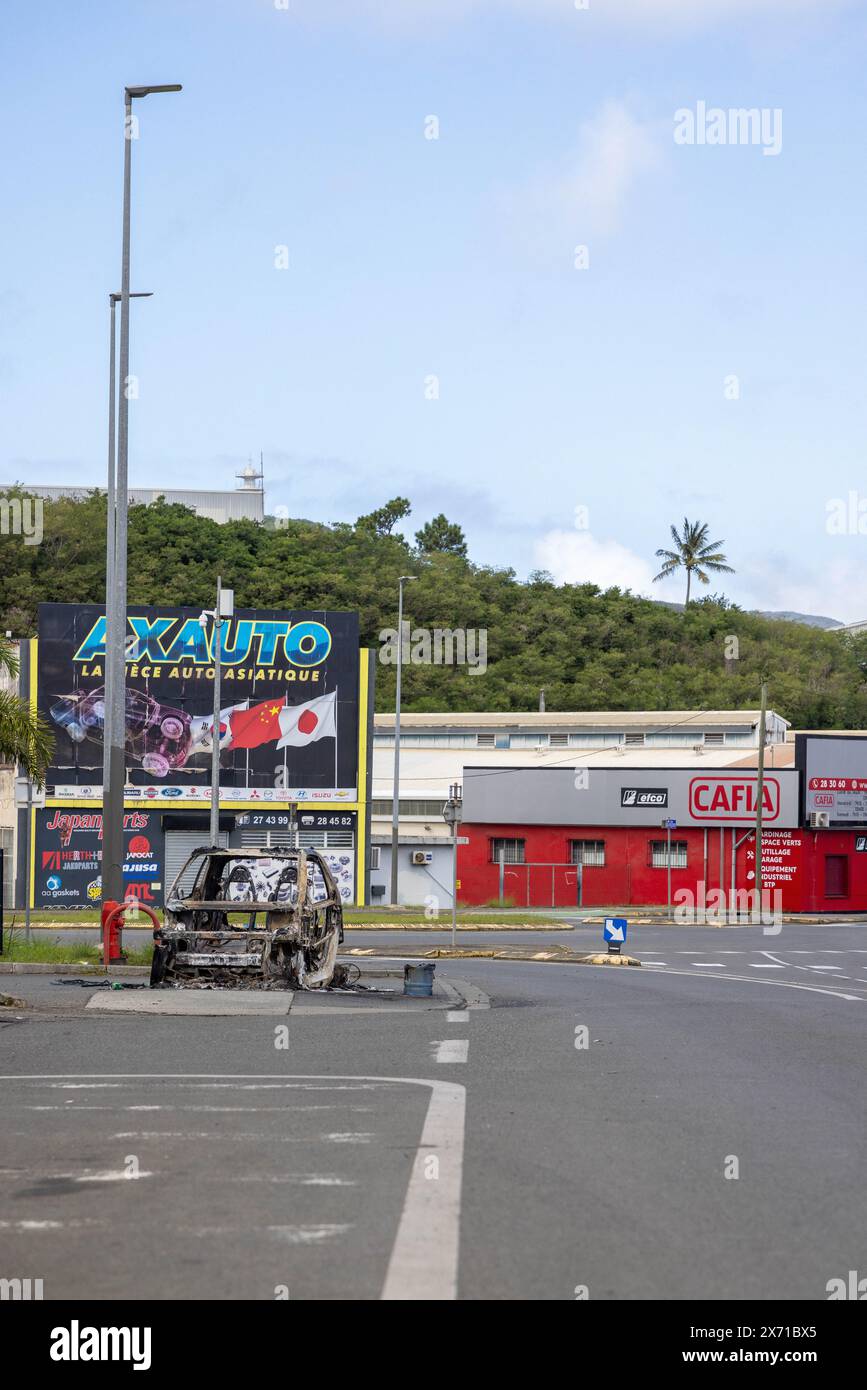 Remains of burned cars and other vandalism carried out by rioters ...