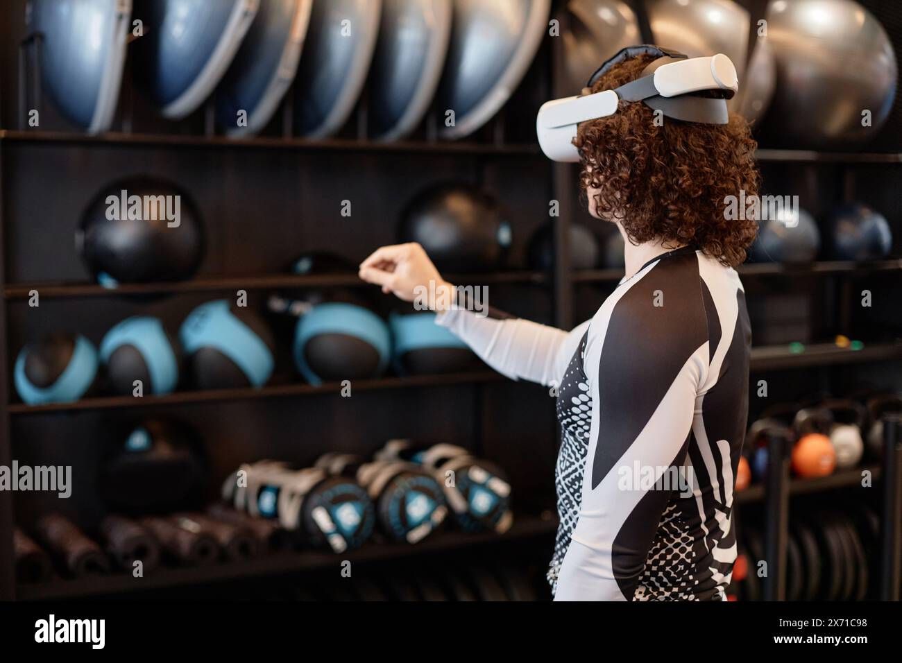 Back view of sportive young man using VR technology for immersive ...