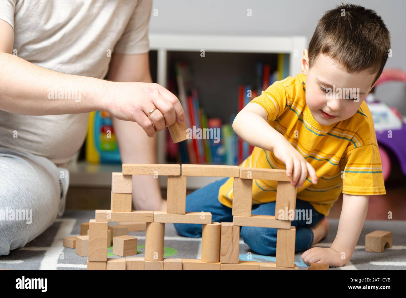 Little toddler boy playing wooden blocks with dad. Spending time with ...