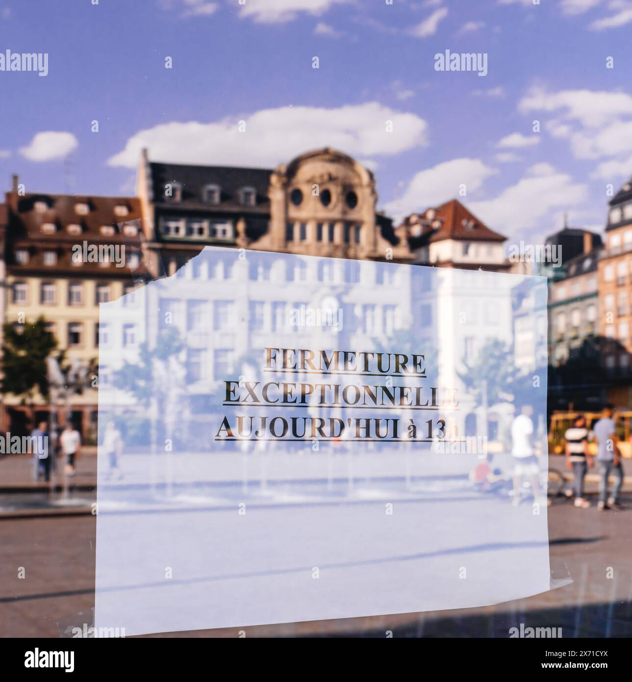 A paper sign on a store window announces an exceptional closure today ...