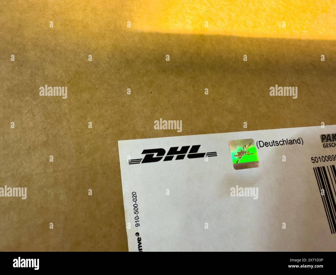 Frankfurt, Germany - Feb 7, 2024: A close-up shot of a DHL sticker with ...