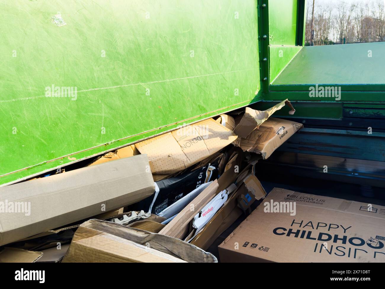 Paris, France - Mar 1, 2024: A green dumpster filled with broken-down ...