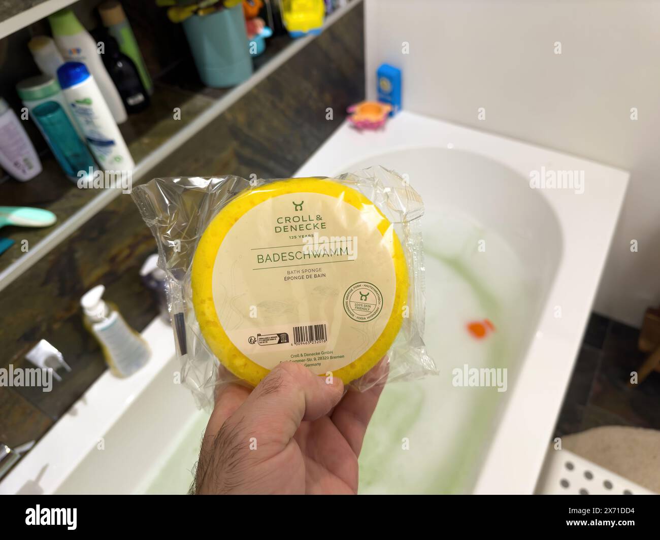 Freiburg, Germany - Mar 3, 2024: A hand holding a packaged yellow bath ...