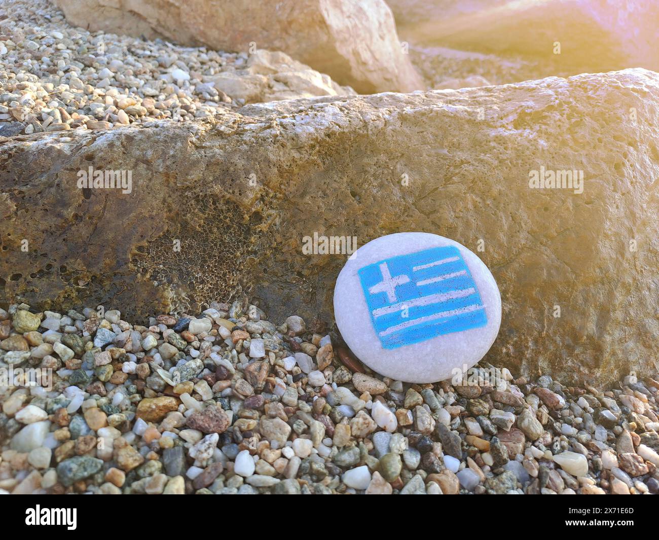 Greece country flag painted on the sea stone on pebble beach background ...