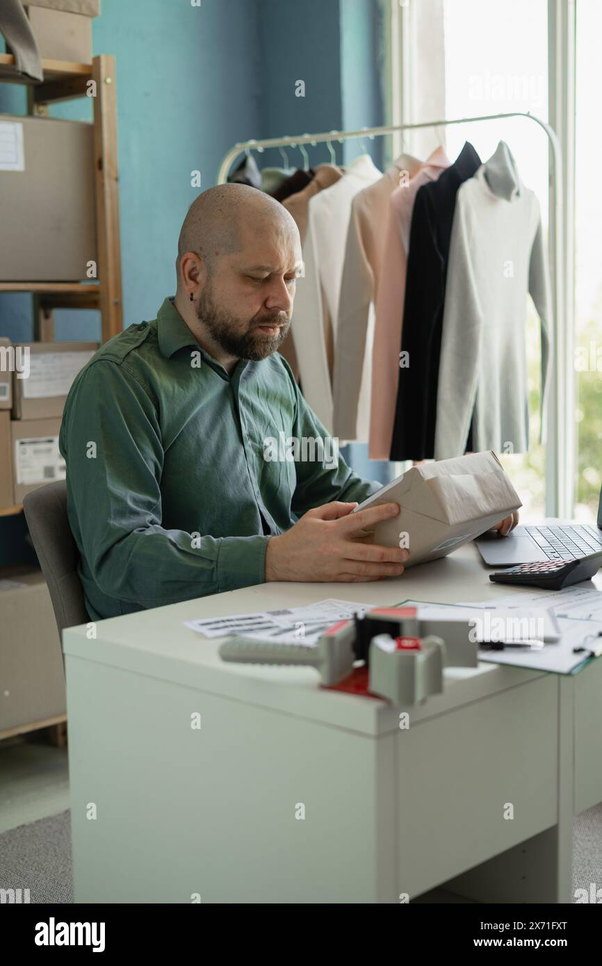 Man holds cardboard package checks hi-res stock photography and images ...