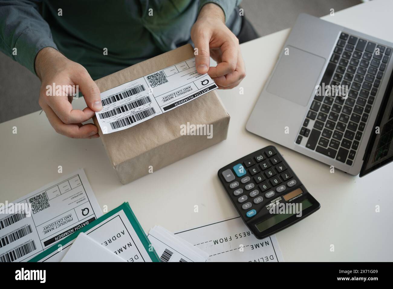 the employee sticks barcode on the parcel and notes in the clients ...
