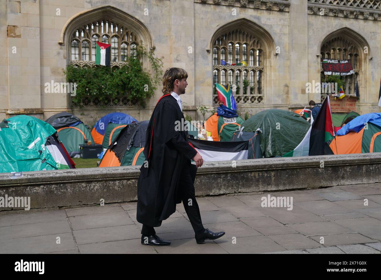 A graduating student walks near an encampment protest over the Gaza ...