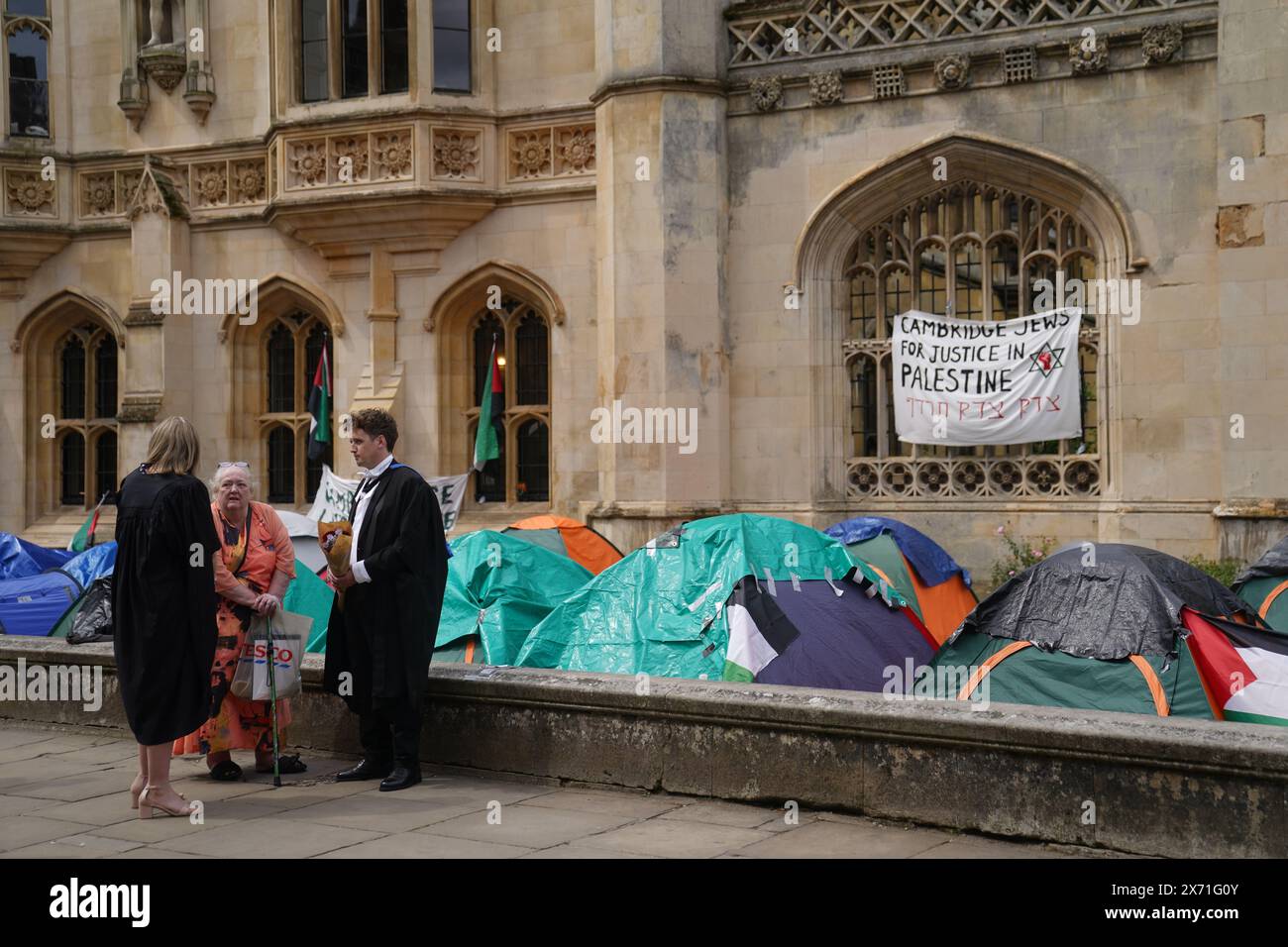Graduating students stand near an encampment protest over the Gaza ...