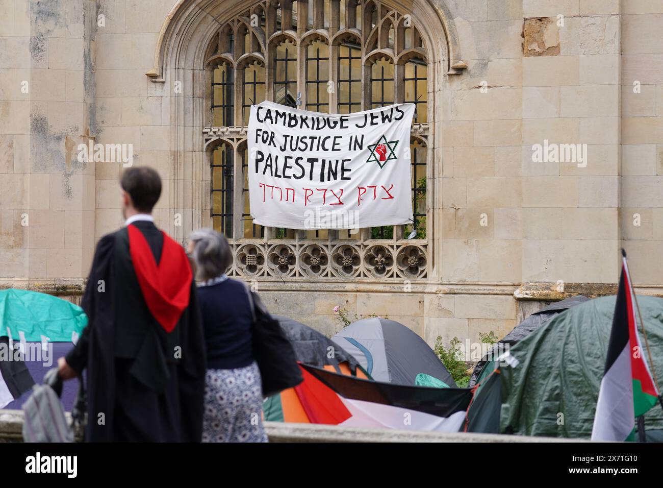 Graduating students stand near an encampment protest over the Gaza ...