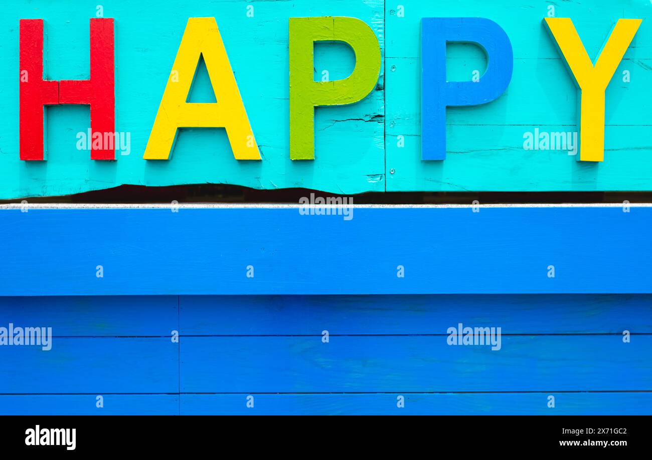 Colorful letters with a word happy, text made with wooden background ...