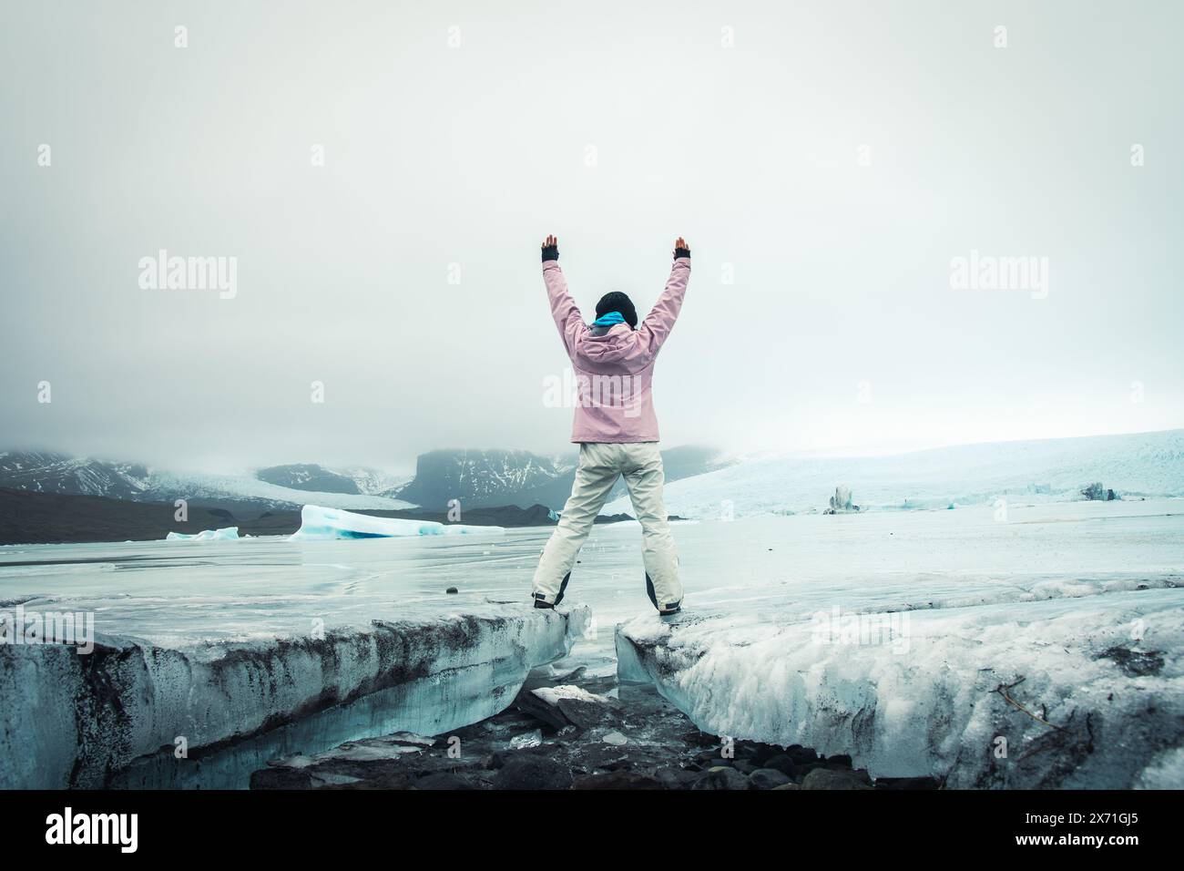 Tourist woman visitor stand by beautiful Fjallsjokull glacier on ice in ...