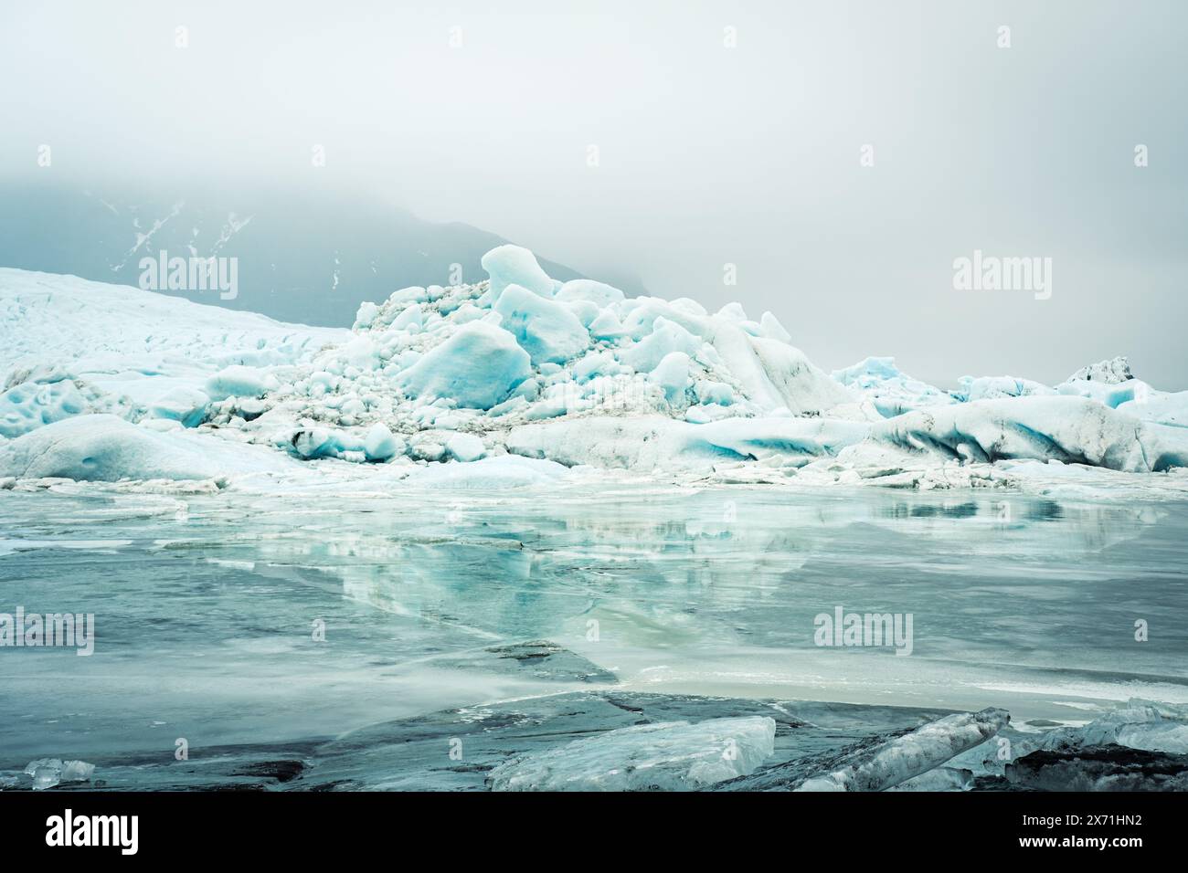 Close up Fjallsjokull glacier icebergs in overcast rainy day in Iceland ...