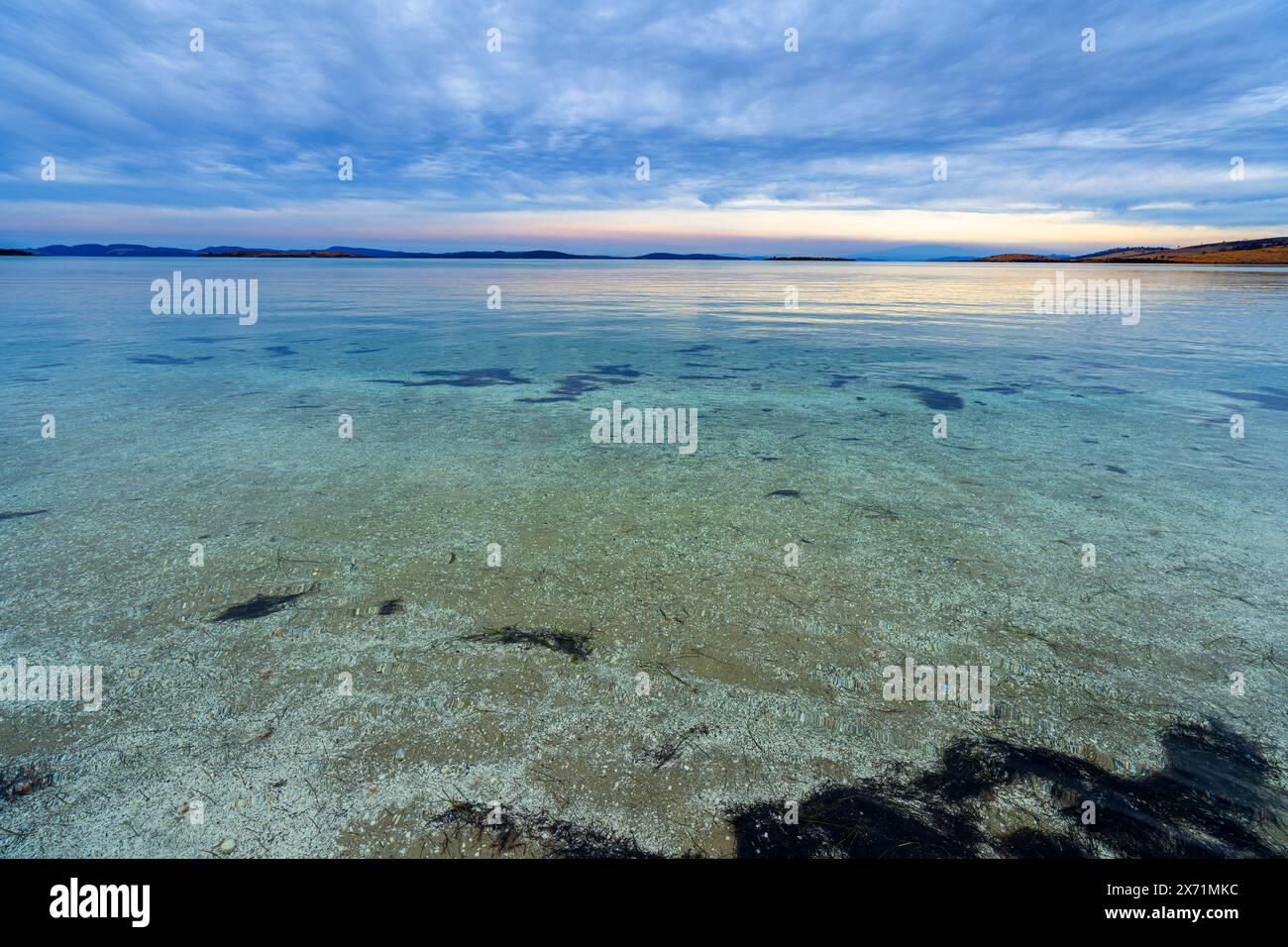 Early morning with calm reflective water at Dunalley Beach, South ...