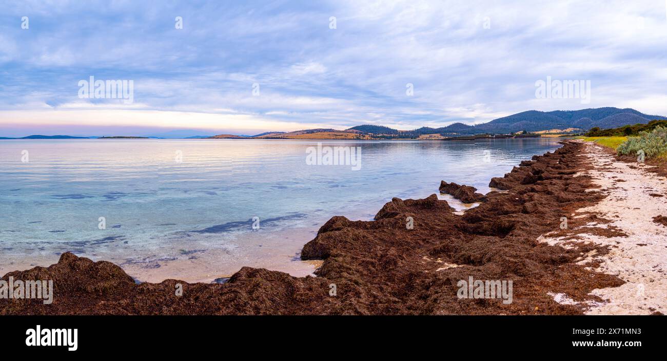 Early morning with calm reflective water at Dunalley Beach, South ...
