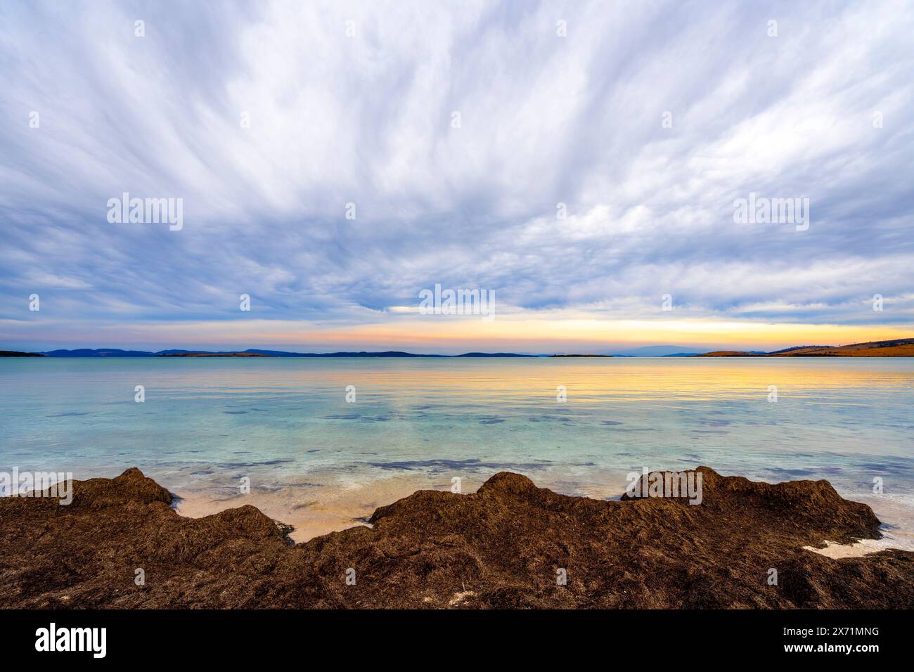 Early morning with calm reflective water at Dunalley Beach, South ...
