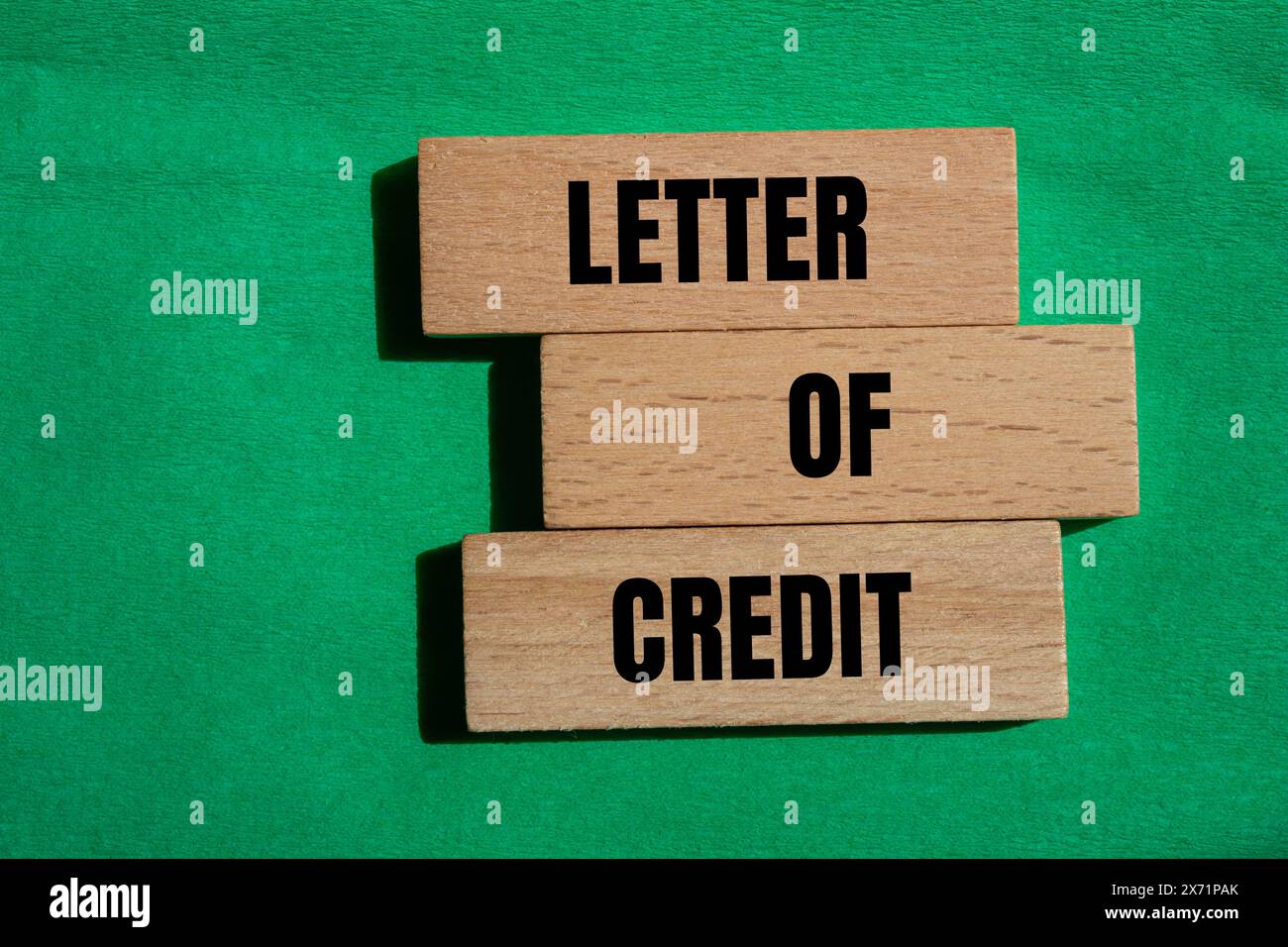 Letter of credit words written on wooden blocks with green background ...