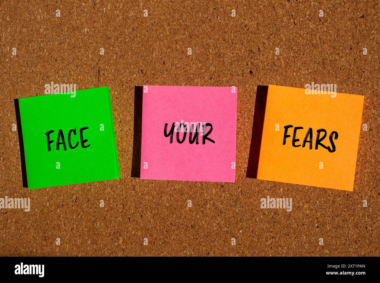 Face your fears words written on colorful papers with brown background ...