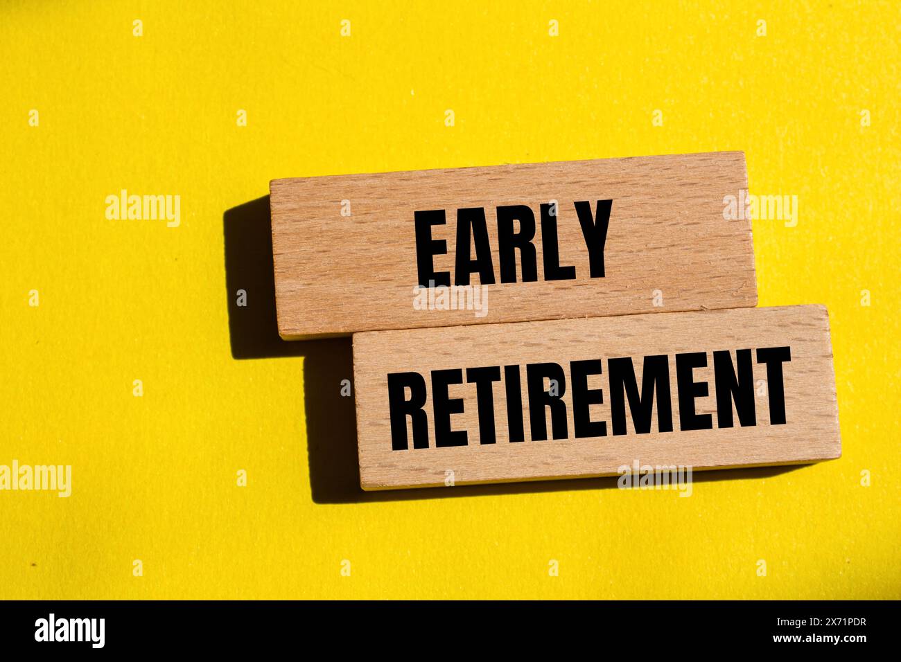 Early retirement words written on wooden blocks with yellow background ...