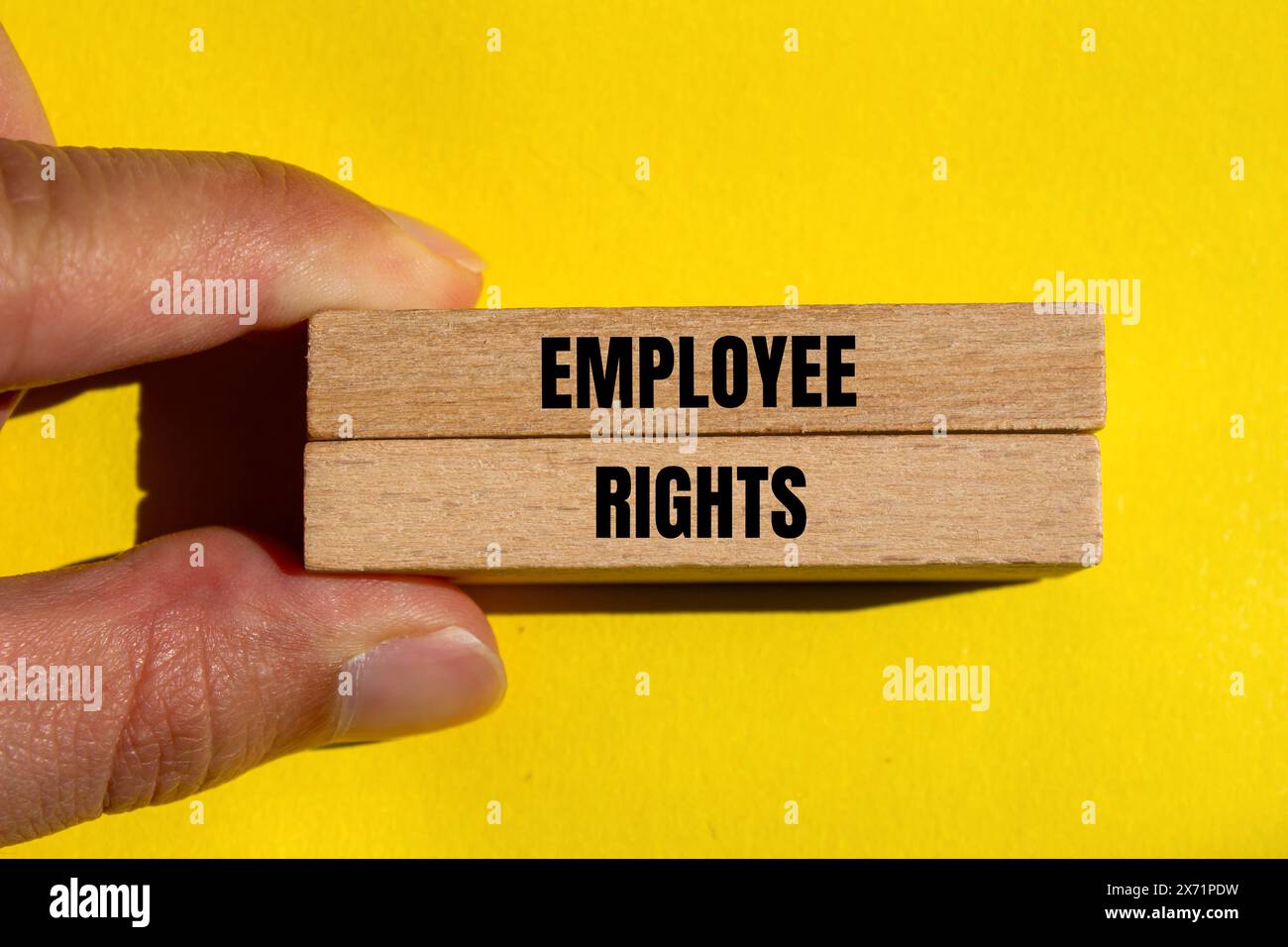Employee rights words written on wooden blocks with yellow background ...