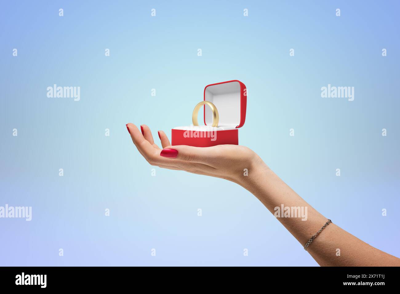 Hand presenting an engagement ring in a box Stock Photo - Alamy