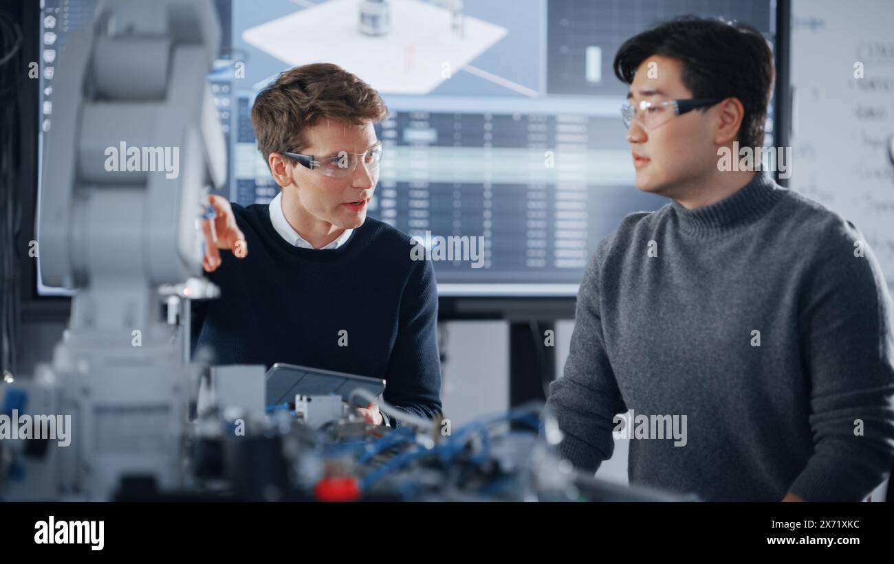 Student Pointing at Robotic Limb and Talking To Classmate While ...