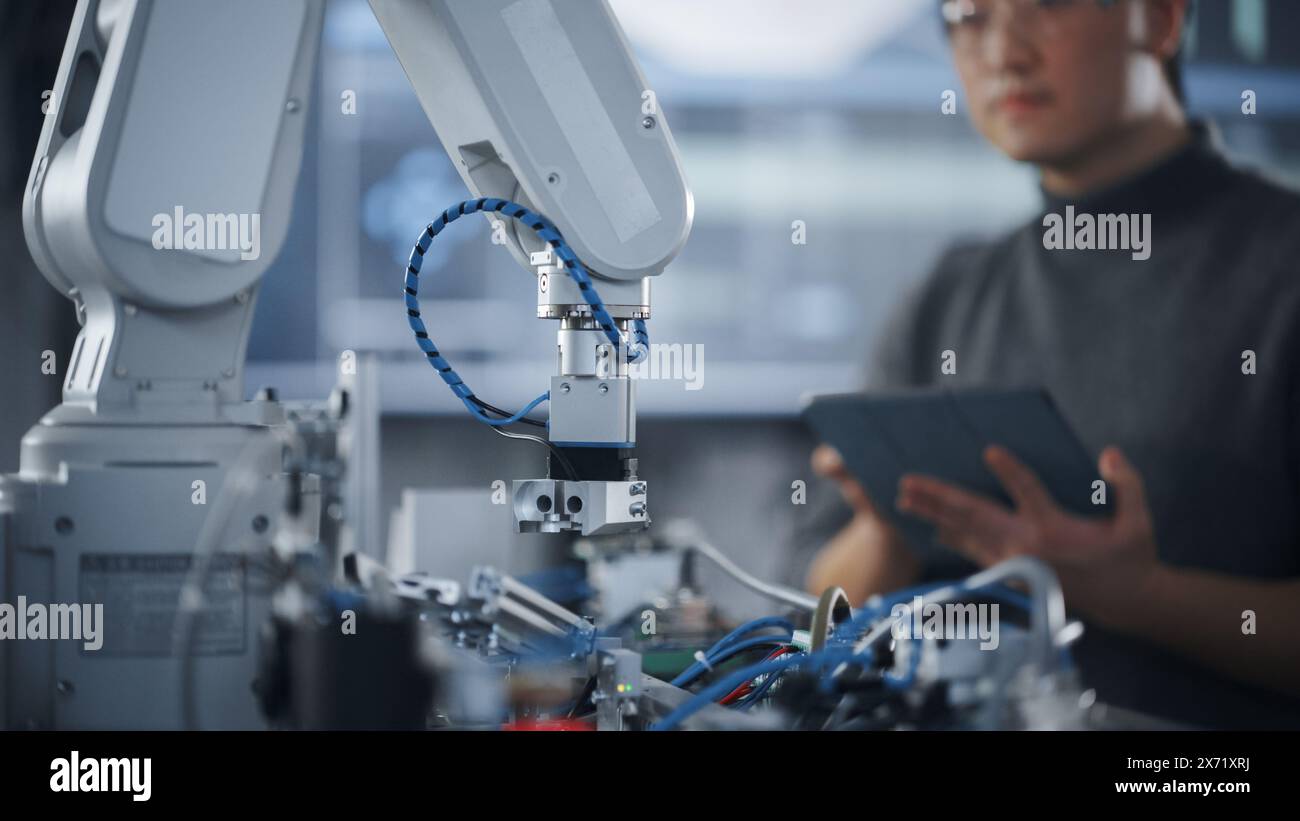 Student Holding Tablet and Controlling Robot Hand Moving at Different ...