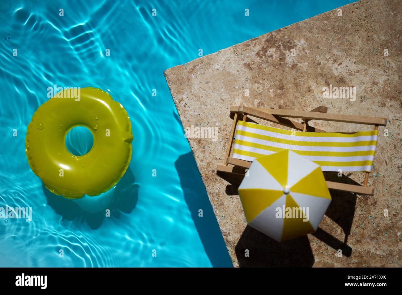 Summer Poolside Relaxation Scene. A bright yellow float and mini deck ...