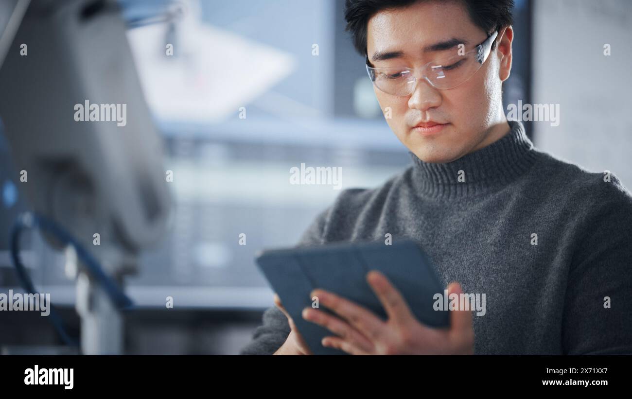 Student Using Tablet to Controll Robotic Hand. Bionic Arm Moving in ...