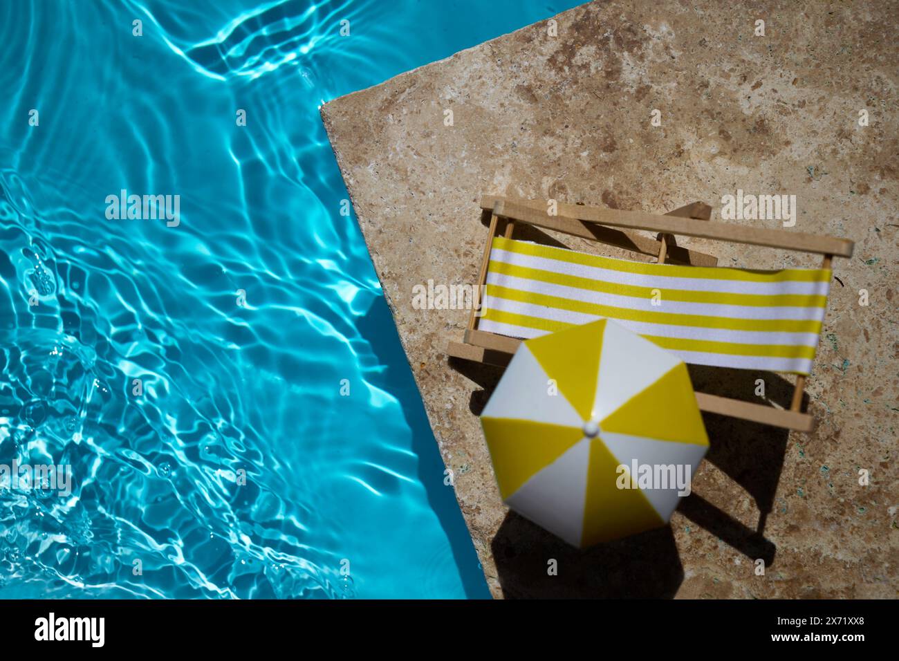 Summer Poolside Relaxation Scene. A bright yellow float and mini deck ...