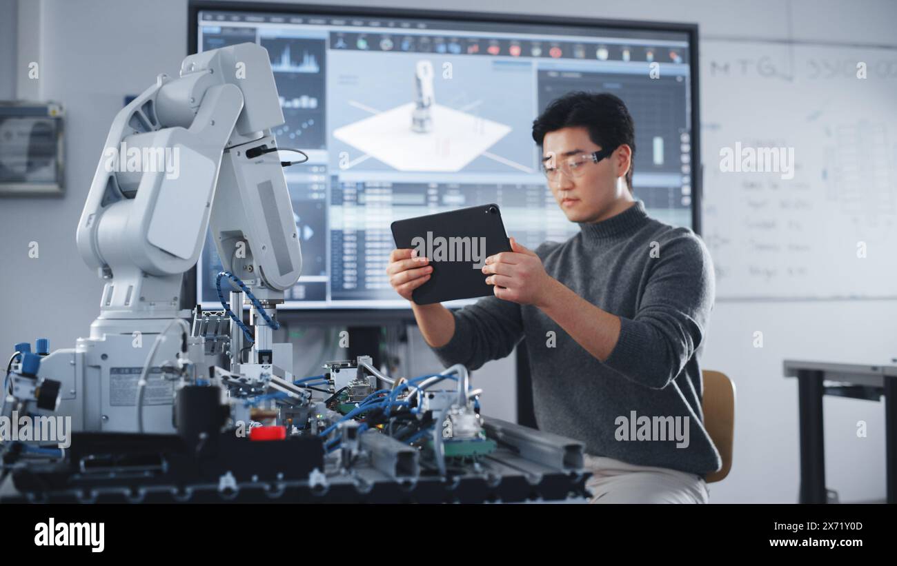 Student Holding Tablet and Controlling Robot Hand Moving at Different ...