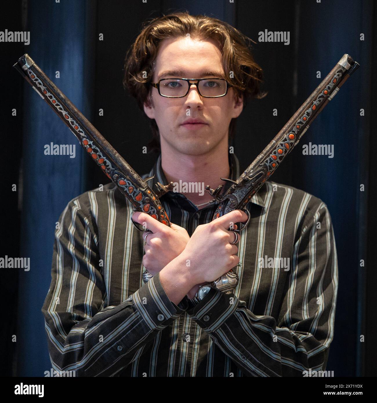 London, England, UK. 17th May, 2024. Bonhams staff member holds a pair ...