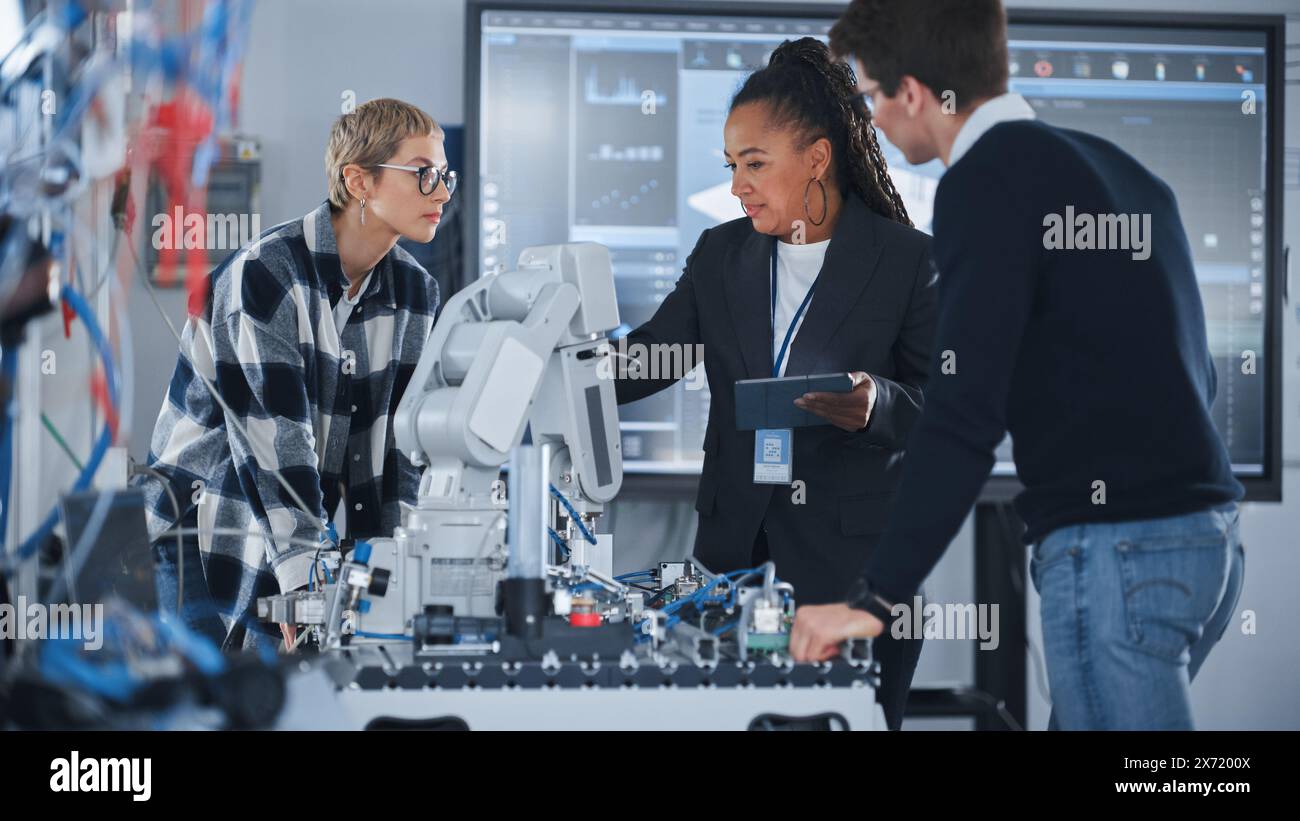 University Robotics Class: Black Teacher Explaining Engineering to Students And Using Robot Arm ...
