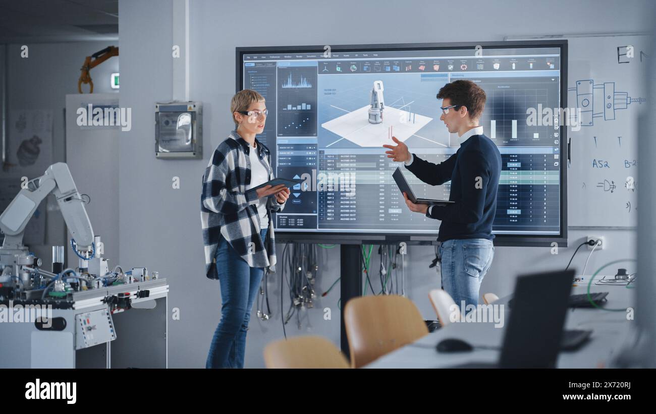 Two Male and Female Students Standing Near Big Screen and Discussing ...