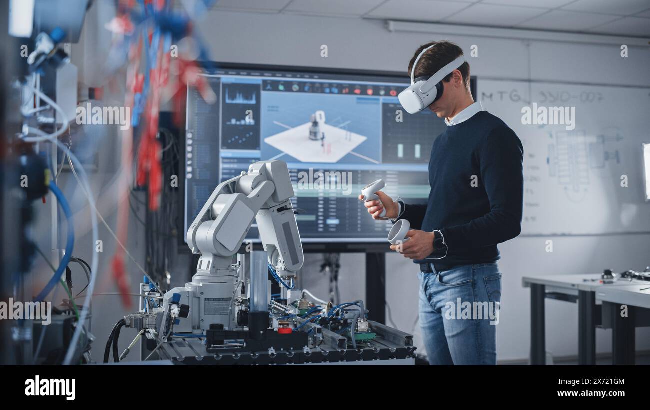 Student Engineer Wearing Virtual Reality Headset Holding Controllers and Moving Bionic Claw ...