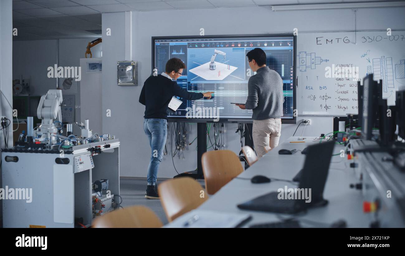 Two Diverse Male Students Standing Near Big Screen and Developing ...