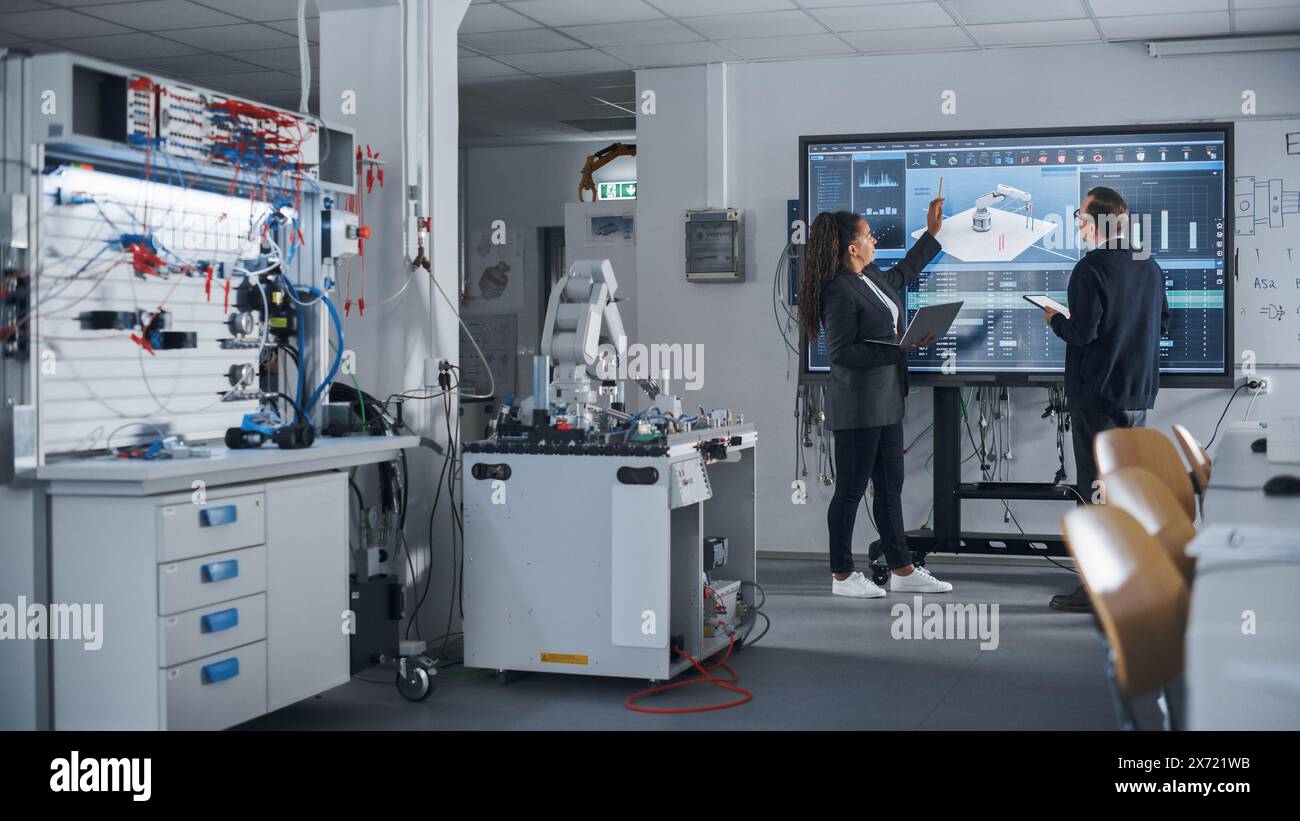 Female Black Developer Looking at Big Screen and Telling her Ideas to ...