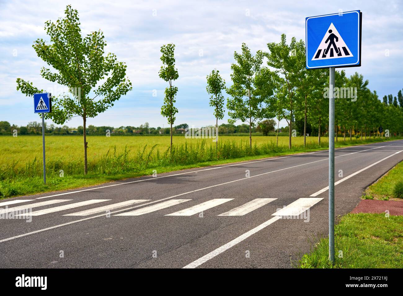 Italy - 4 May 2024: Pedestrian crossing with warning sign and crosswalk ...