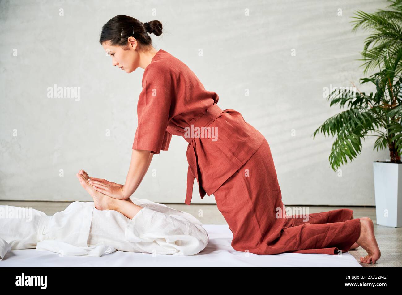 Masseuse Making Thai Yoga Massage Woman Therapist Doing Traditional Massage Treatment