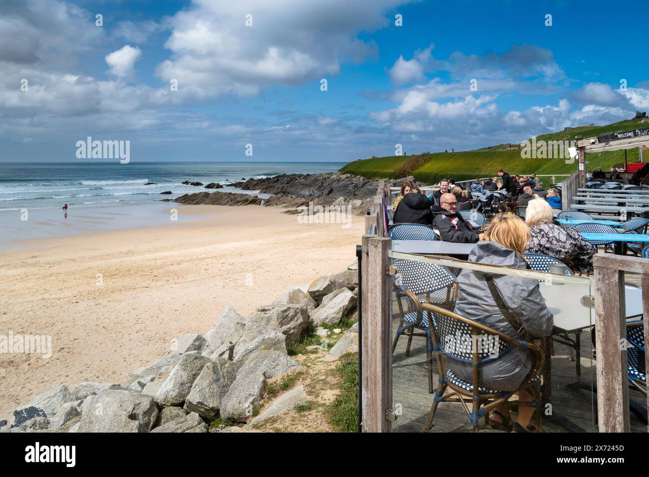 Holidaymakers sitting and relaxing on the outdoor decking area of the ...