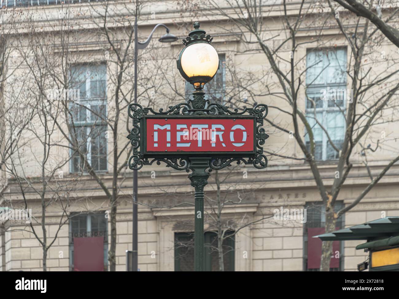 France, Paris - Jan 04, 2024 - A pole with traditional metro sign under ...