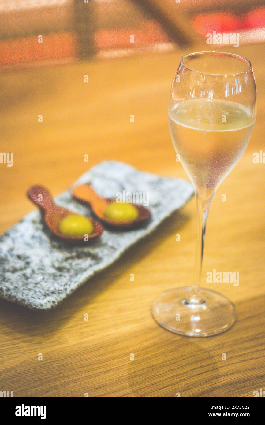 two amuse bouche of spherical Olives and a glass of sparkling wine ...
