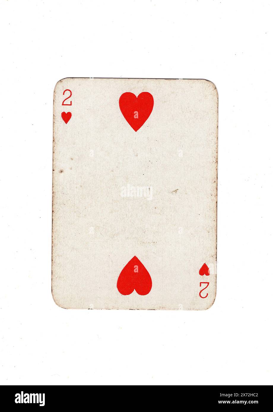 An antique two of hearts playing card isolated on a white background ...